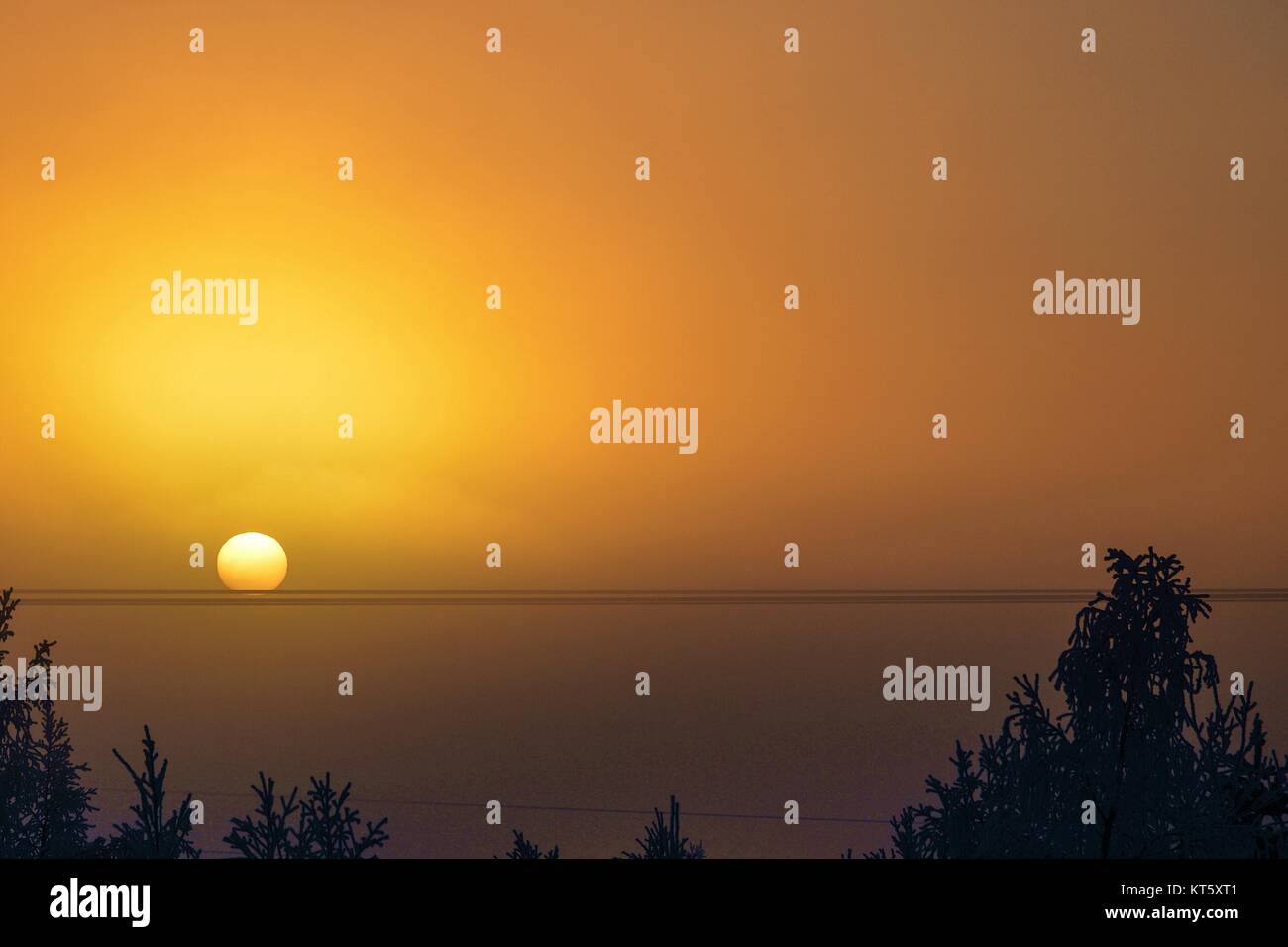 the sun is balancing on the power line Stock Photo - Alamy