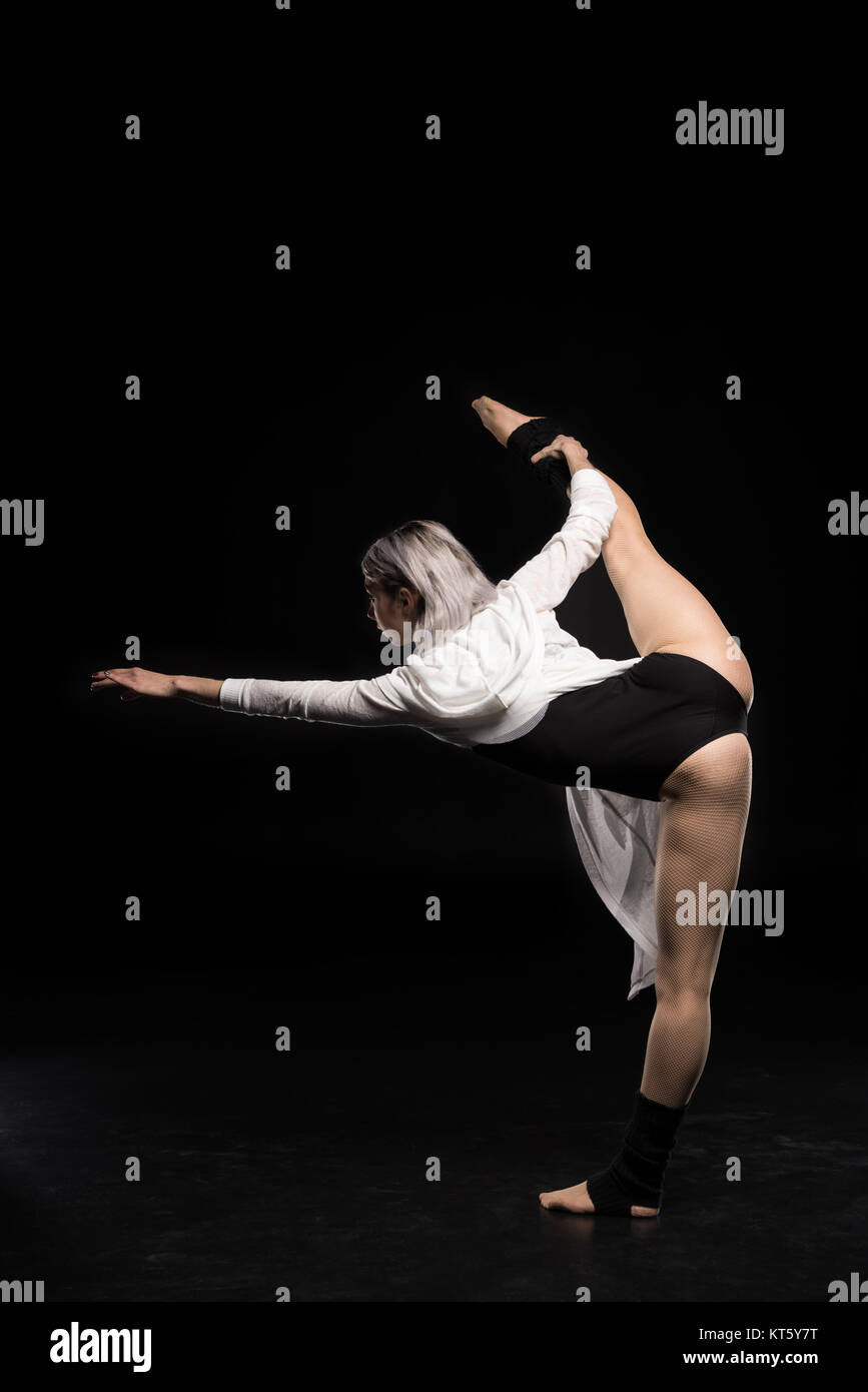 back view of woman in bodysuit dancing on black Stock Photo - Alamy