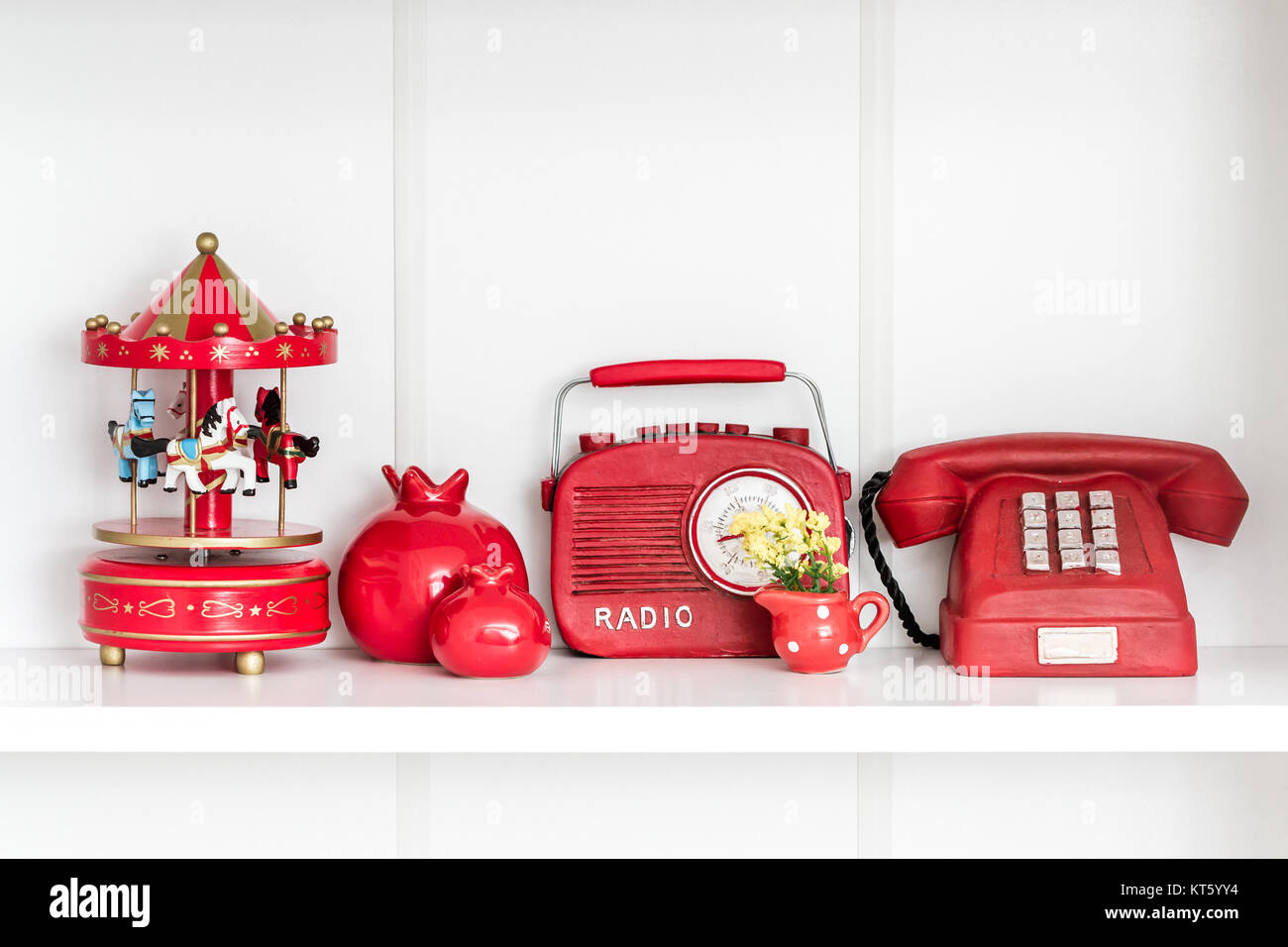Red Home Related Decorative Objects in a White Shelf Stock Photo - Alamy