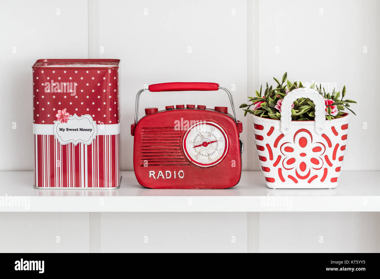 Red Home Related Decorative Objects in a White Shelf Stock Photo - Alamy