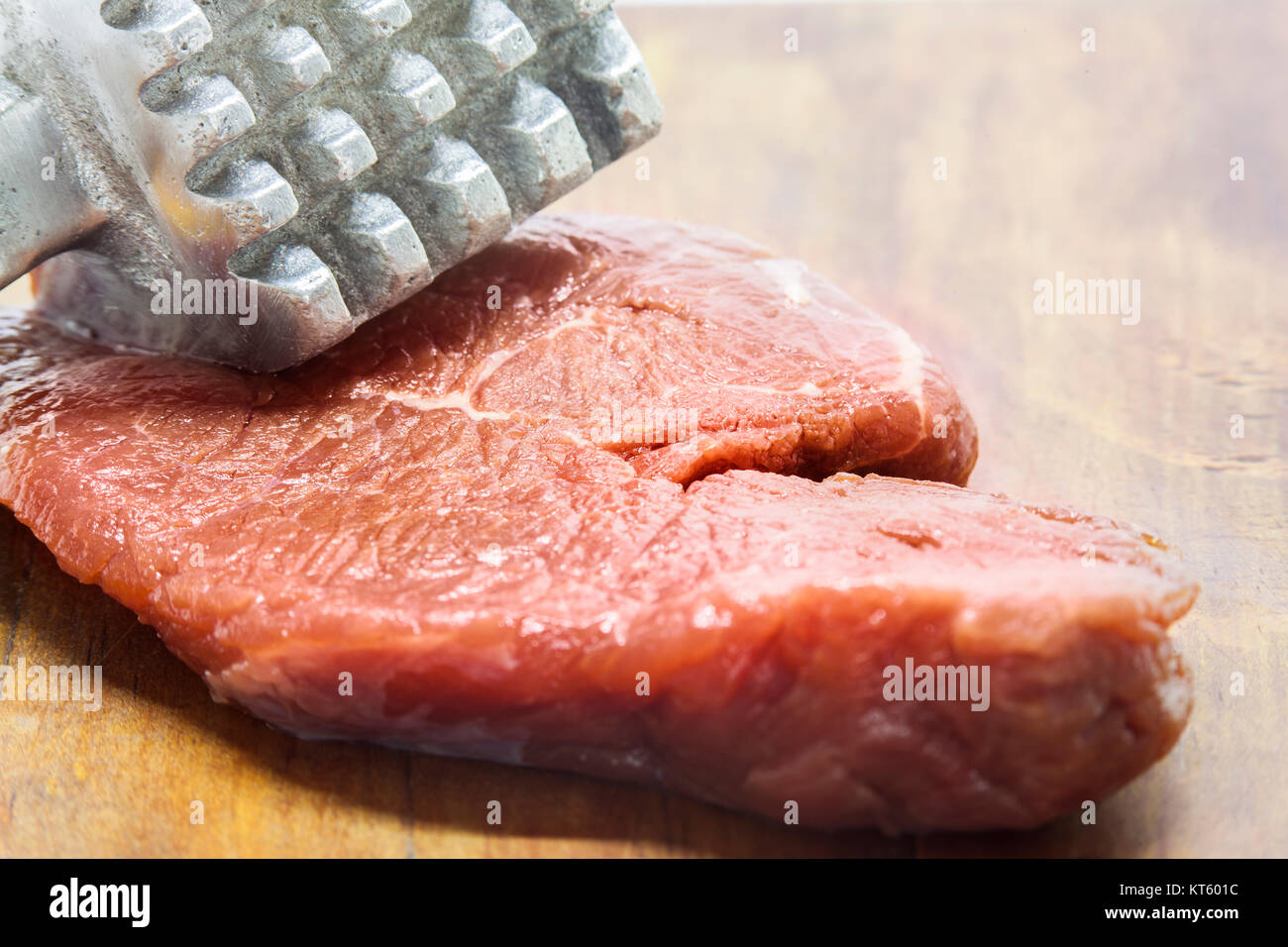 Close up of raw beef meat and hammer Stock Photo - Alamy