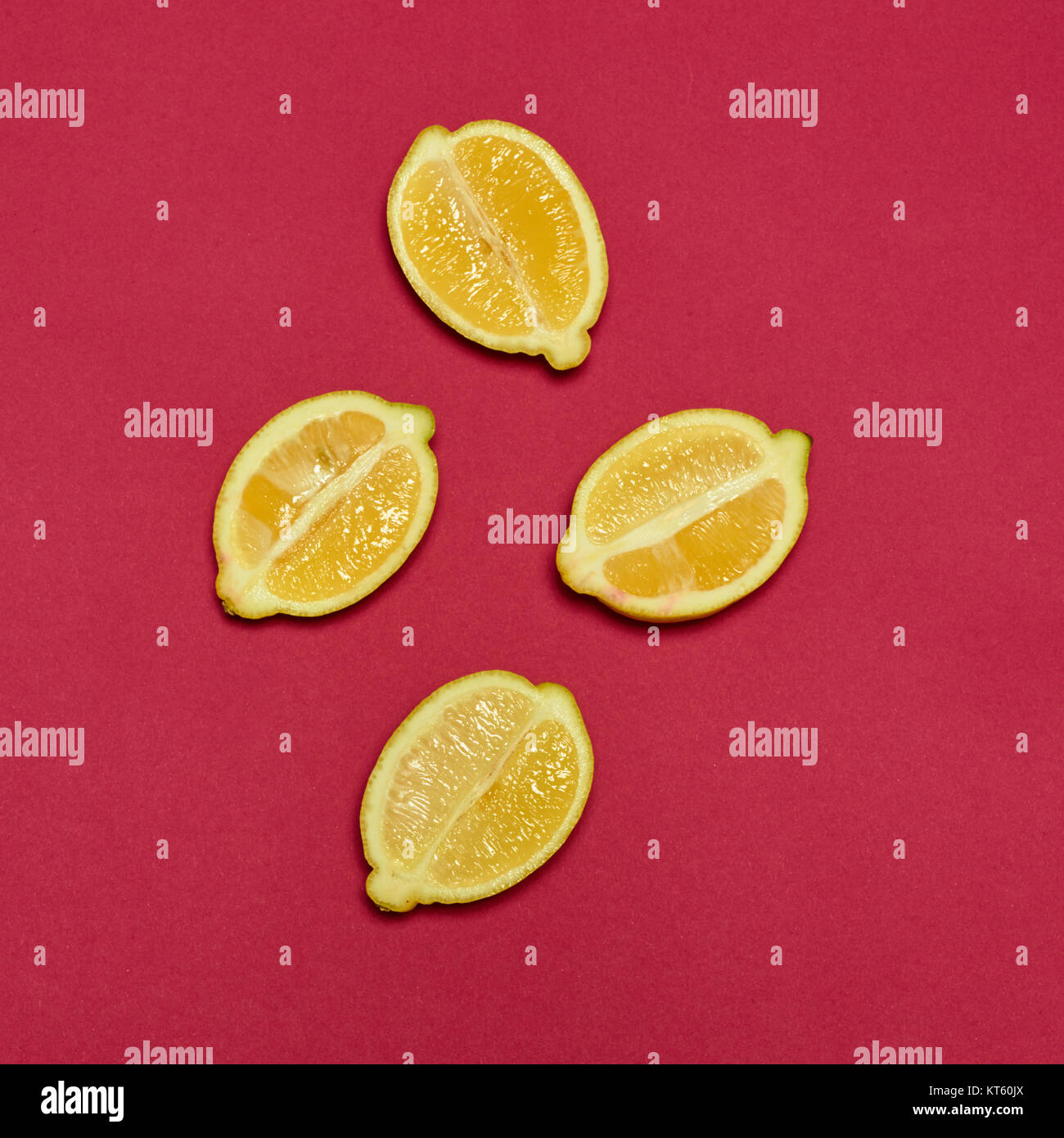 Lemons on red background Stock Photo - Alamy