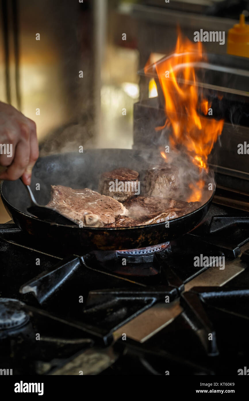 Chef frying meat steak Stock Photo - Alamy