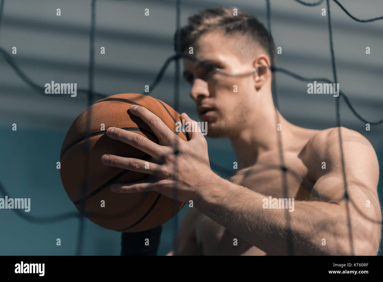 side view of sporty man holding basketball ball in hands Stock Photo ...