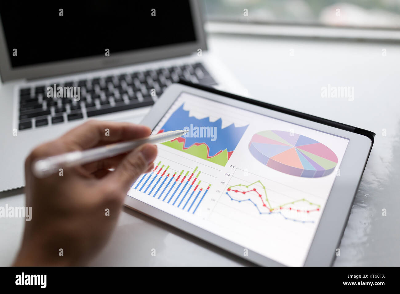 Pen showing the information graph on tablet computer Stock Photo - Alamy
