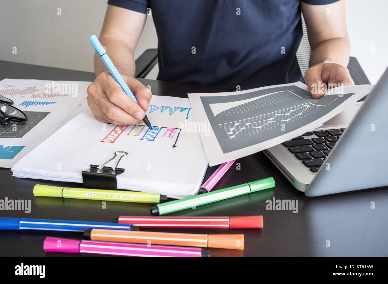 Man writing graph on paper with color pen Stock Photo - Alamy