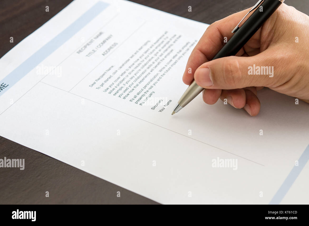 Close-up man signing on resume form Stock Photo - Alamy