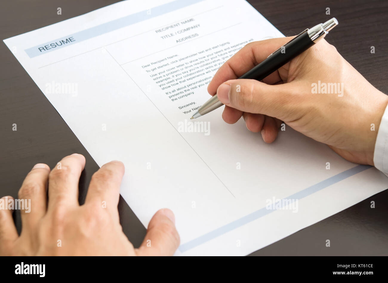 Close-up man signing on resume form Stock Photo - Alamy
