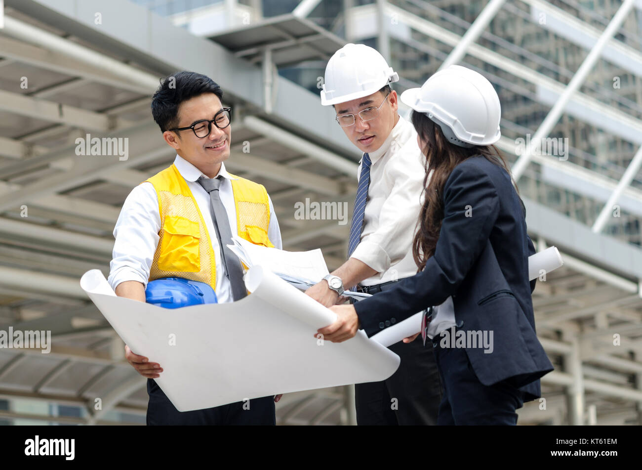 Group of asian architects discussing about new project with paperwork ...