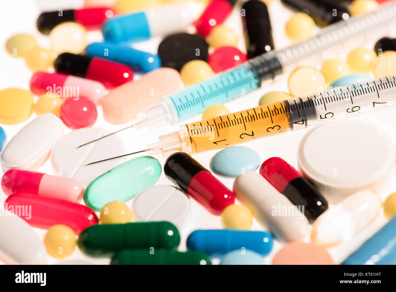 Close-up view of colorful medical pills and syringes, medicine and ...