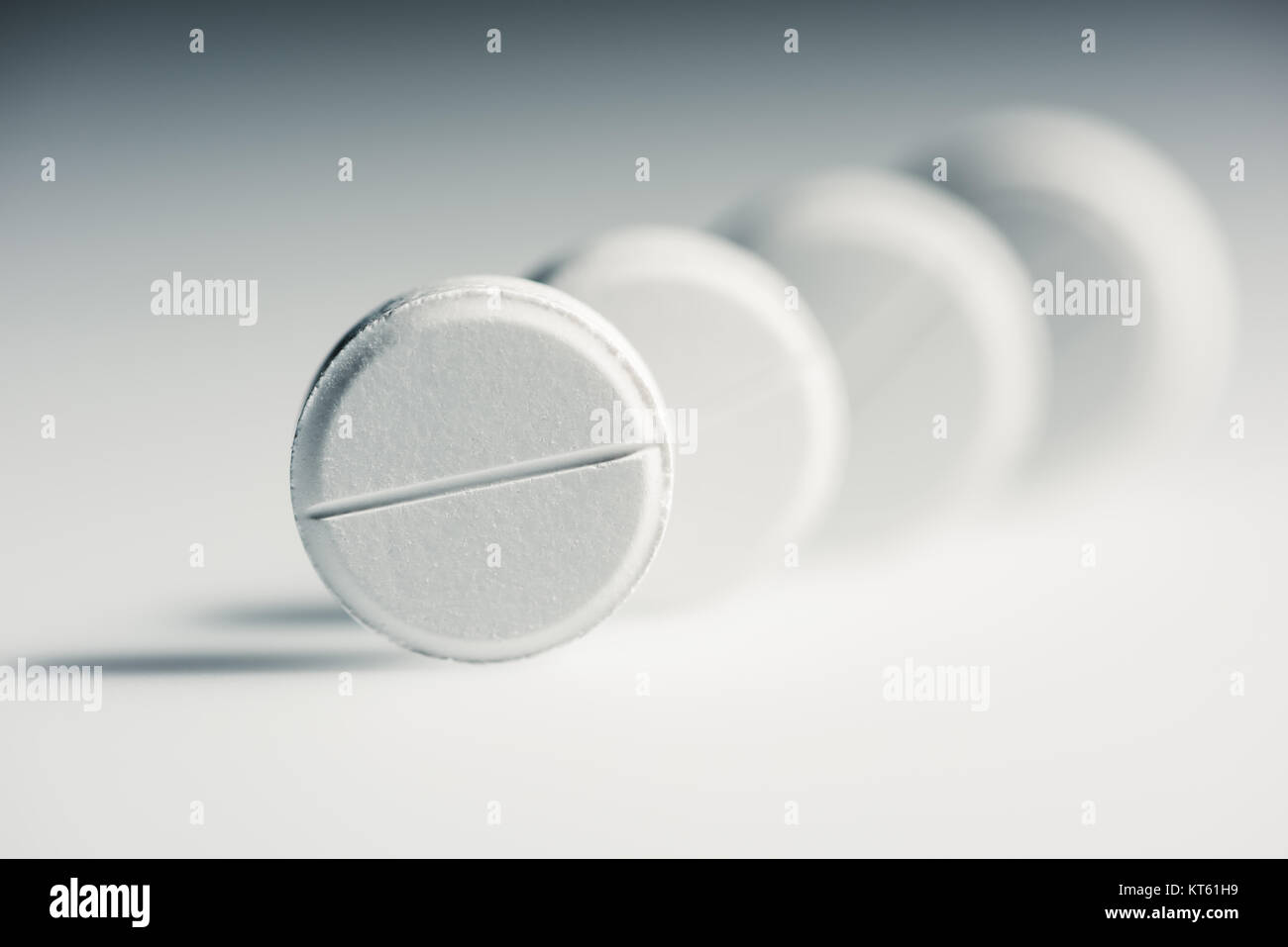 Close-up view of round white medical tablets on grey, medicine and ...