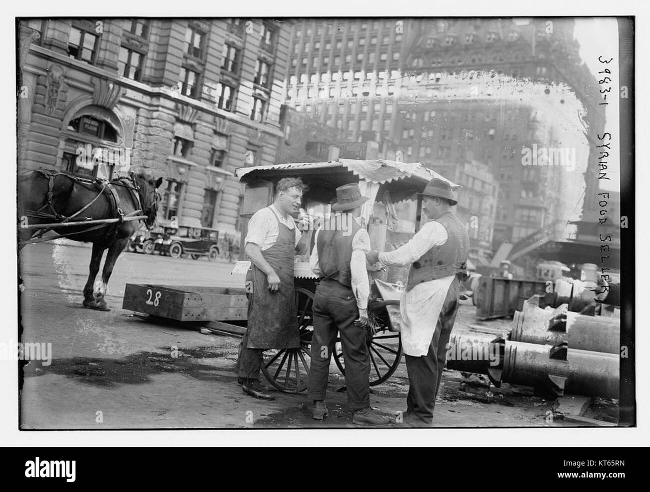 A photograph of a Syrian food seller at a market, showcasing the ...