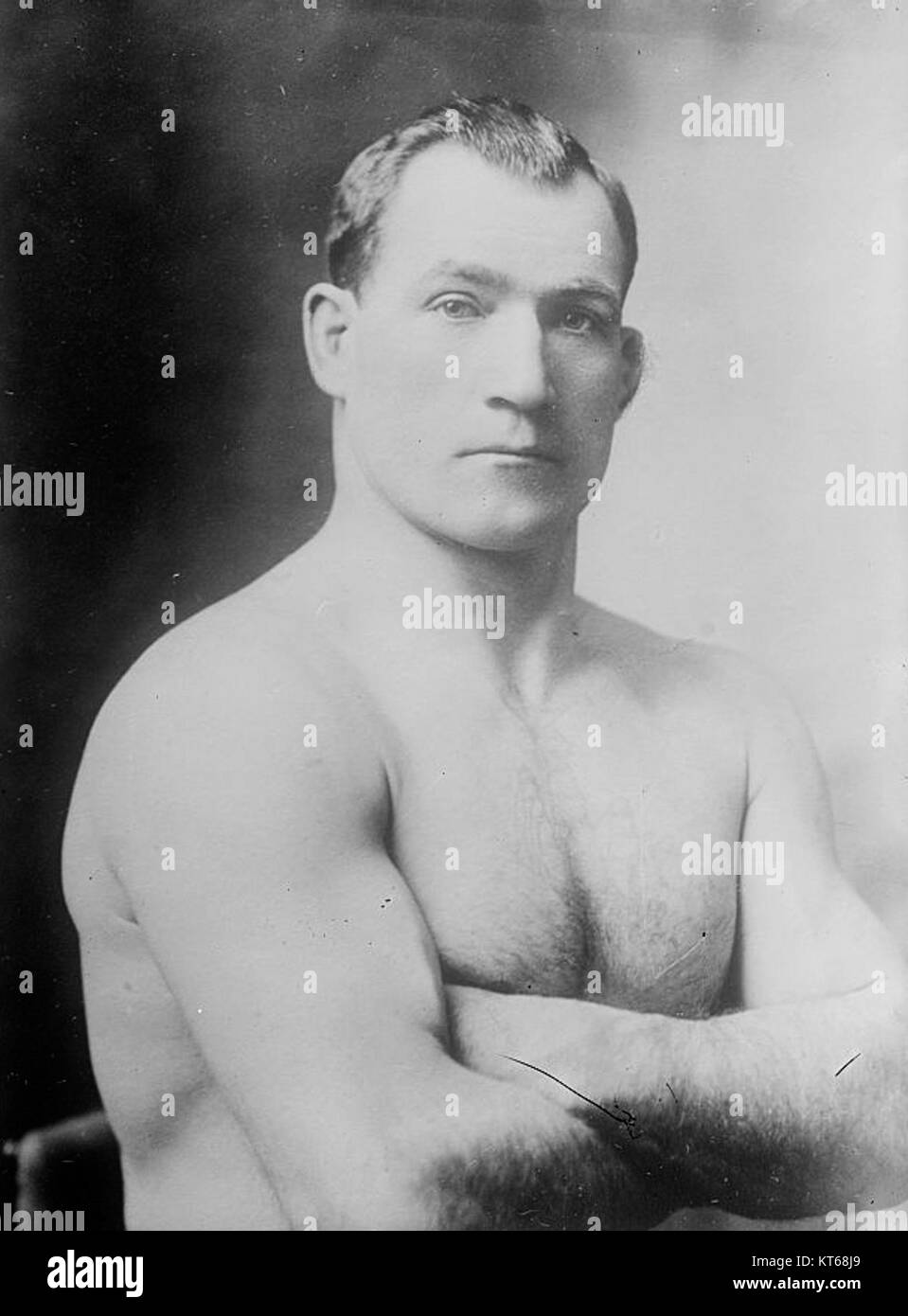 Tom Sharkey, an American boxer from the early 20th century, is captured ...