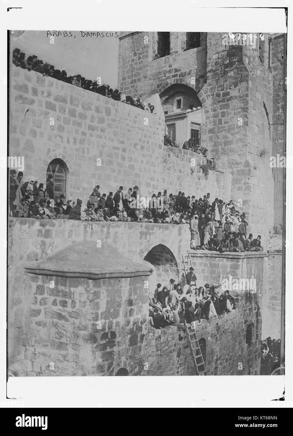 This photograph captures a group of Arabs in Damascus, providing a ...