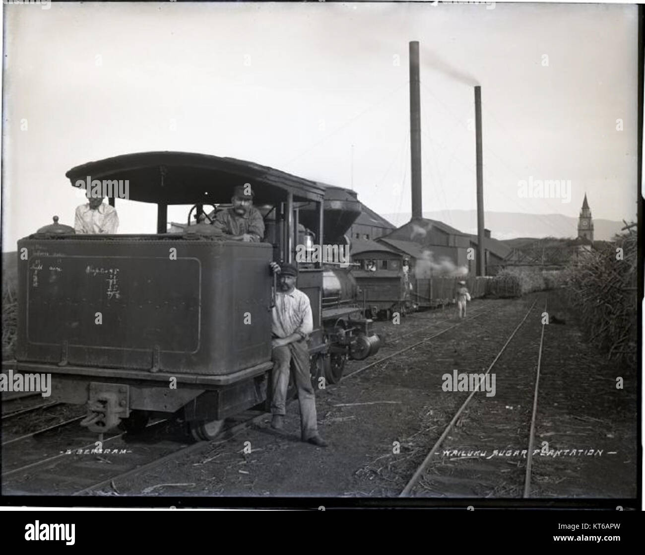The photograph showcases the Wailuku Sugar Plantation with a train ...