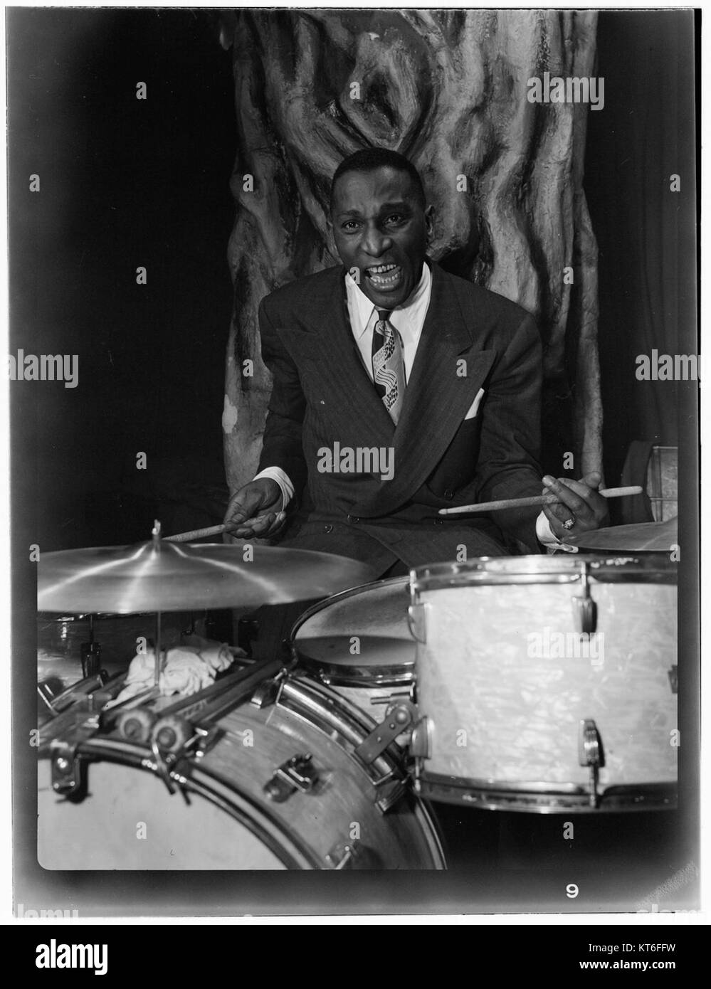 This portrait features Cozy Cole, a renowned American jazz drummer ...