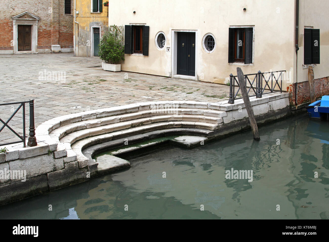 Steps leading to small pier on canal in Venice Stock Photo - Alamy