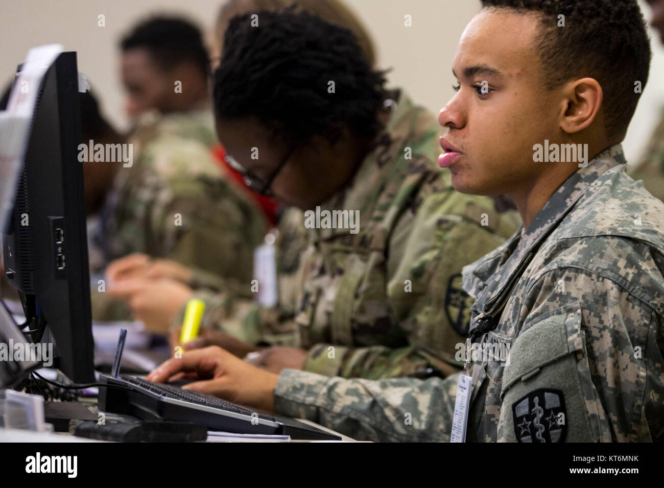 Spc. Aaron Parson, 7250th Medical Support Unit, processes a soldier ...