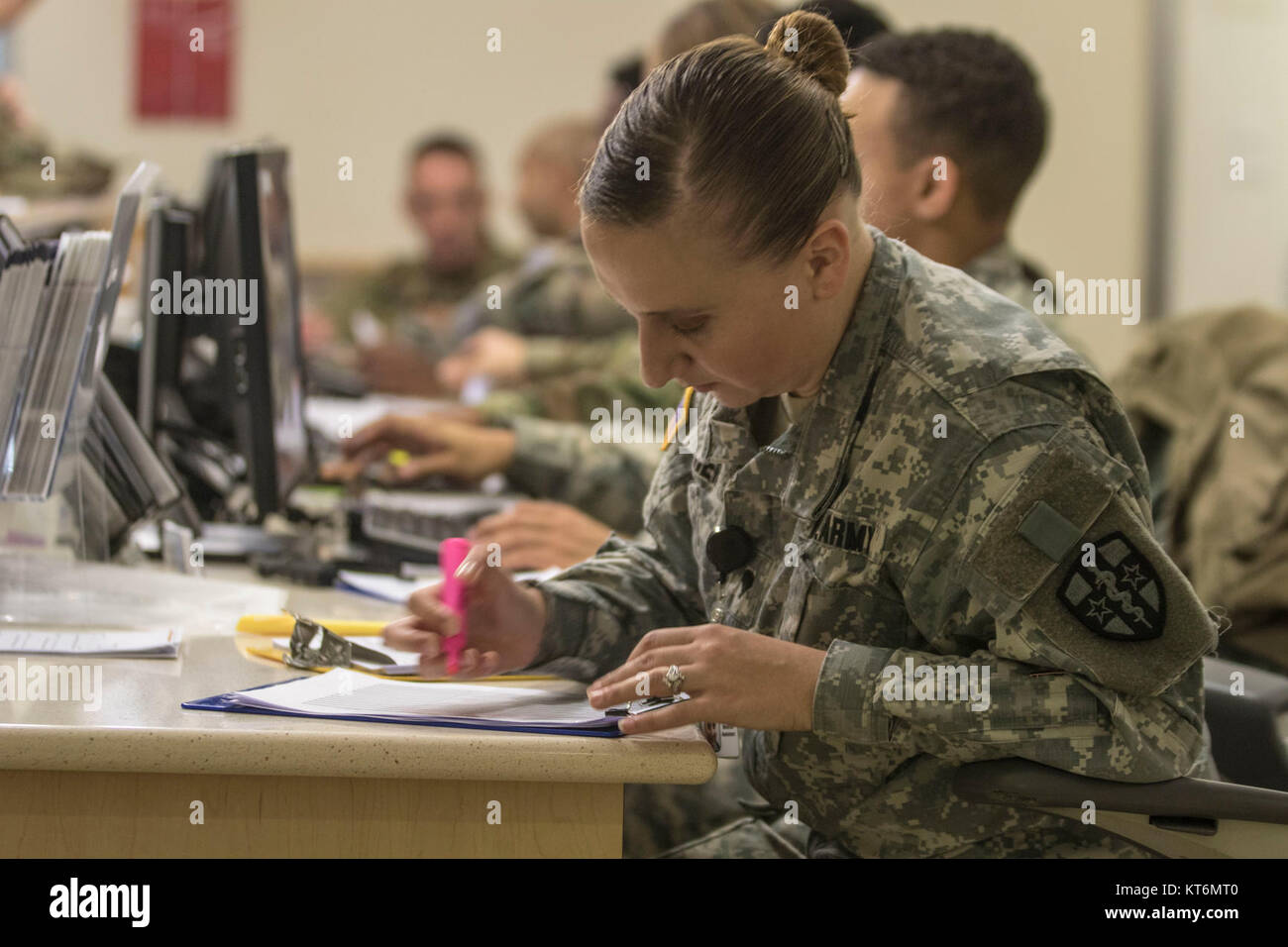 Spc. Rebekah Pletcher, 7250th Medical Support Unit, processes a soldier ...