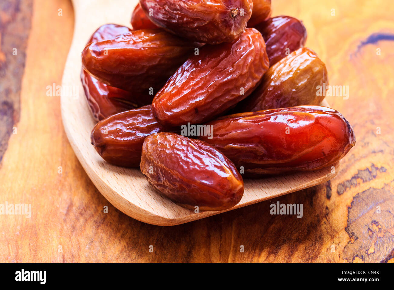 Healthy eating. Closeup dried dates on spoon table wooden background ...
