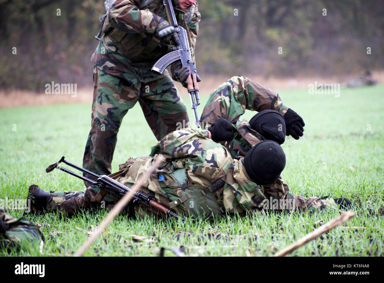 A Moldovan Special Operations Forces member lifts the body of an enemy ...