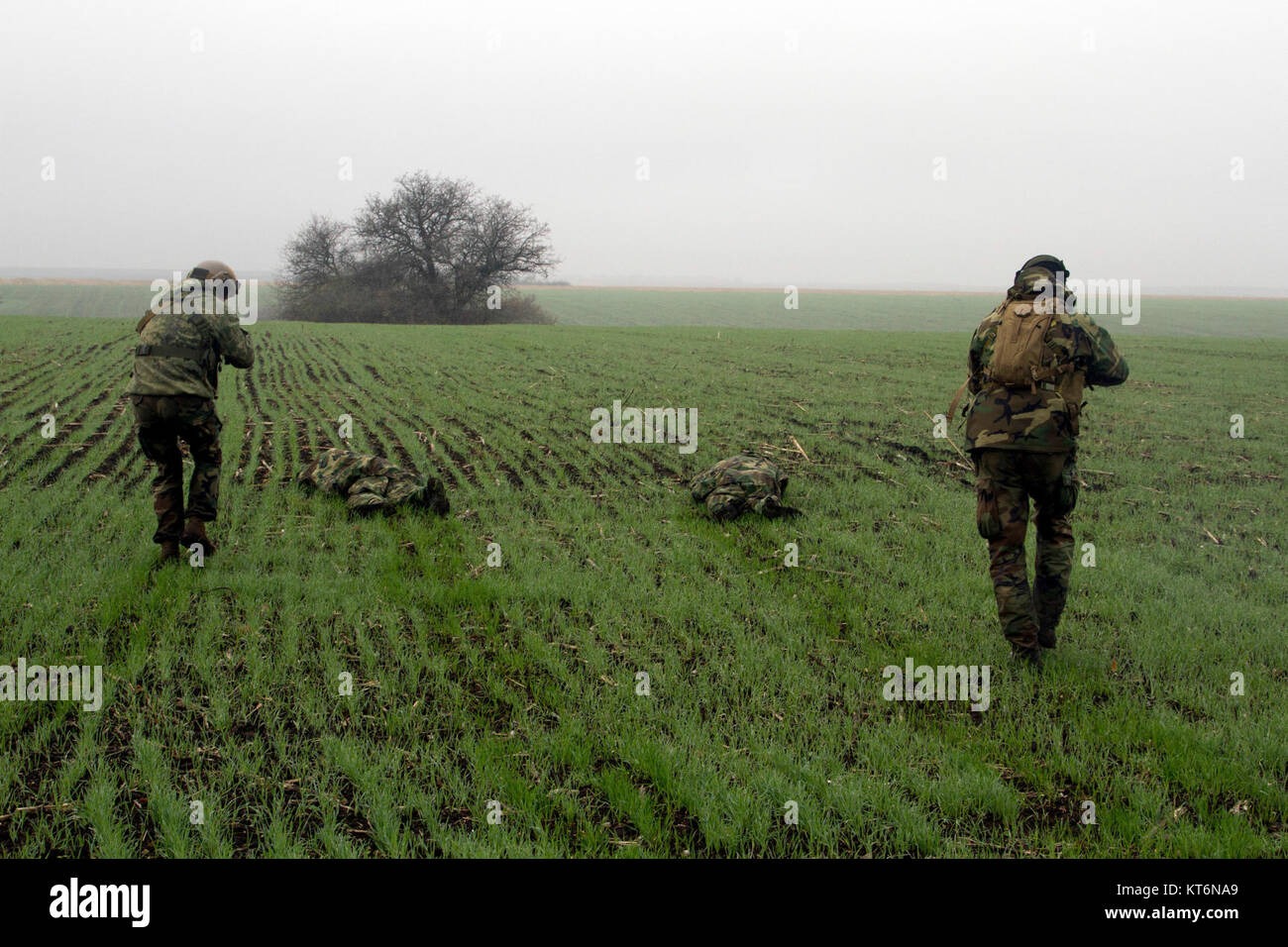 Two Moldovan Special Operations Forces approach fallen enemy combatant ...
