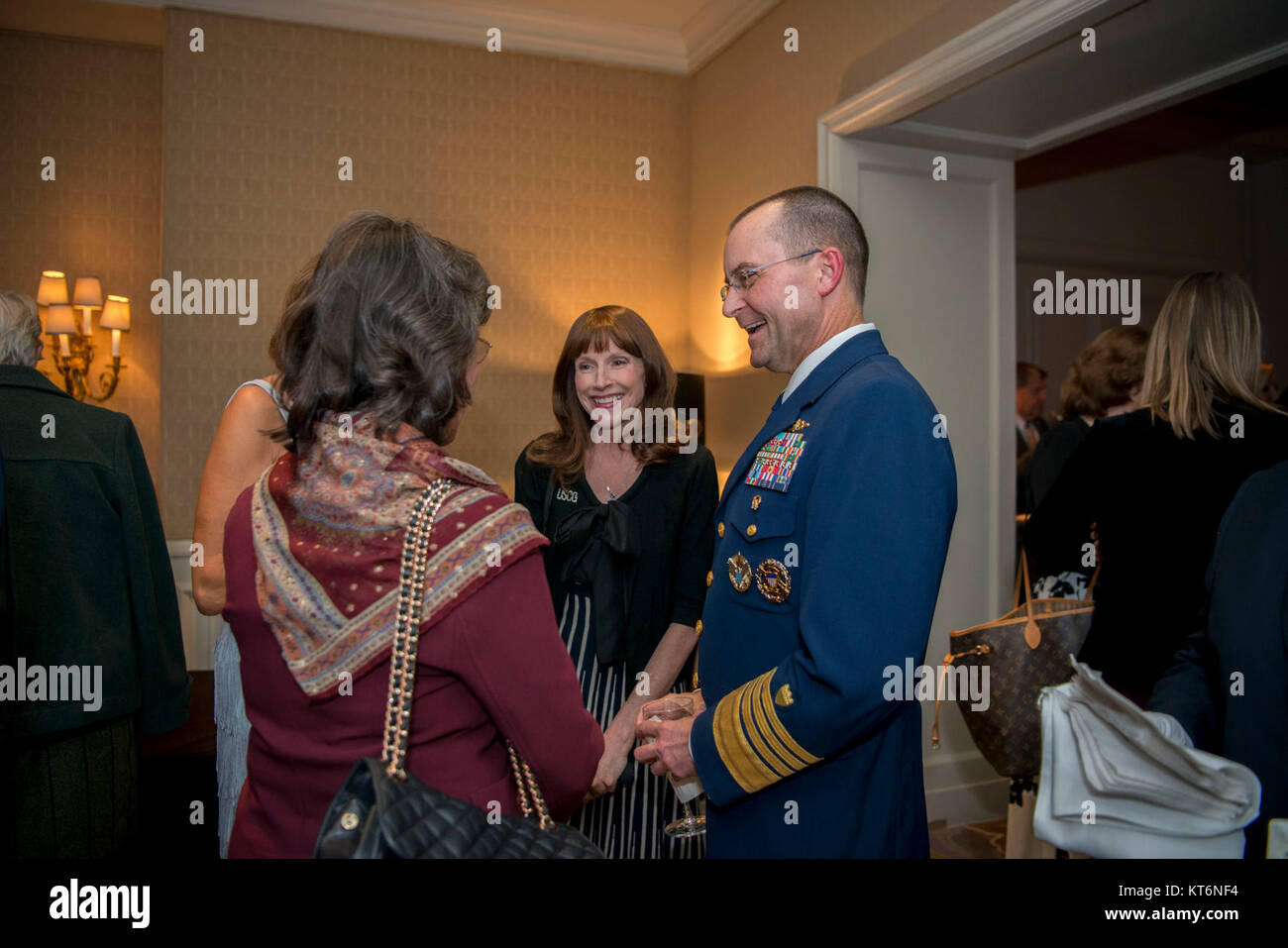 Coast Guard Vice Commandant Adm. Charles Michel talks to several people ...