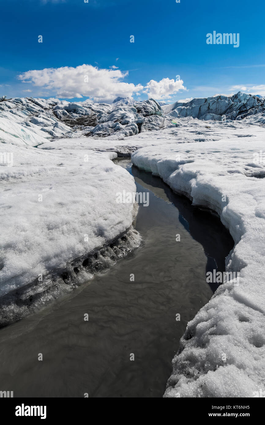 Melting water gathered into a glacial lake near the end of Matanuska ...