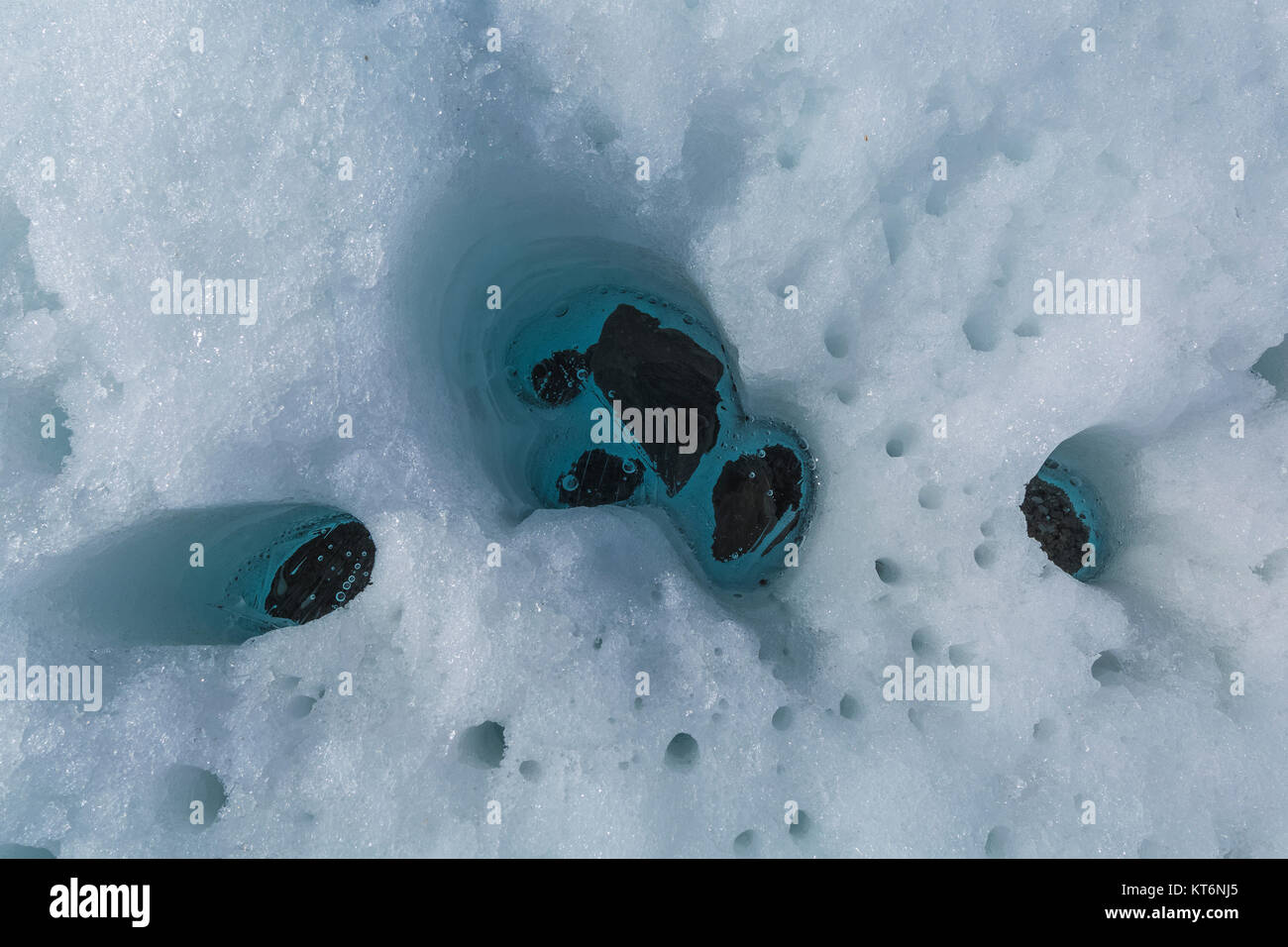 Pattern of holes created by little stones melting through the snow on ...