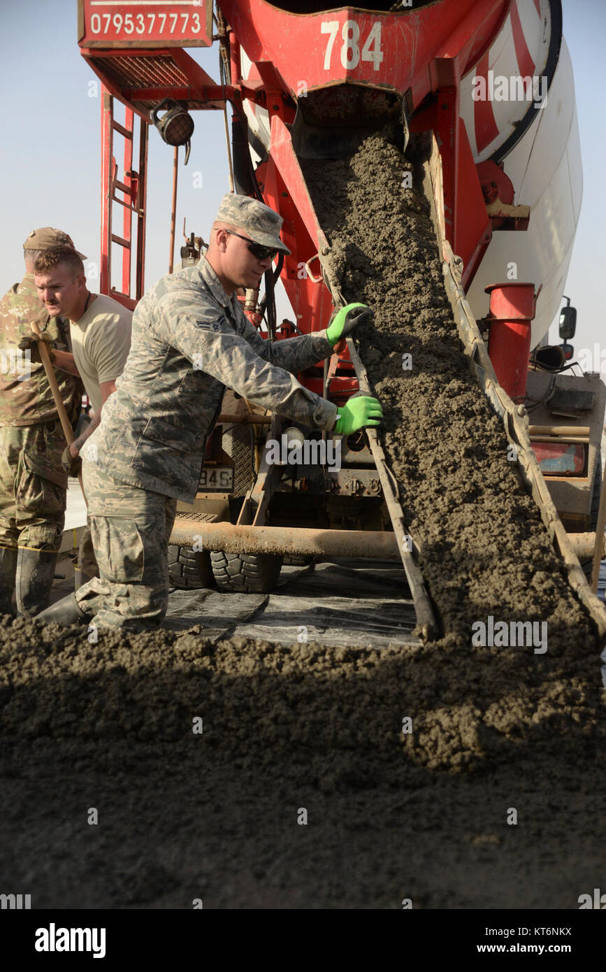 Airman 1st Class Jerre Myrick, a heavy equipment operator, guides wet ...