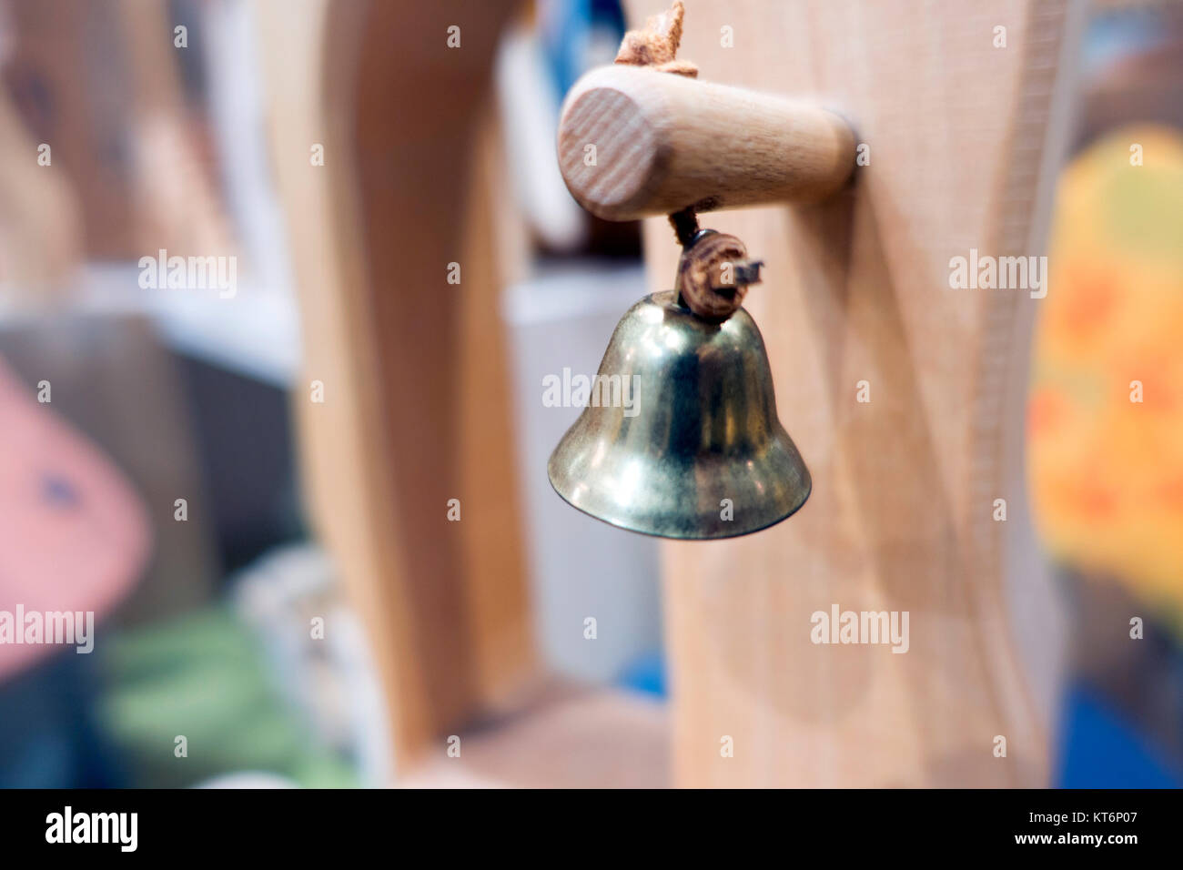 gold hanging bell on a wood toy Stock Photo - Alamy