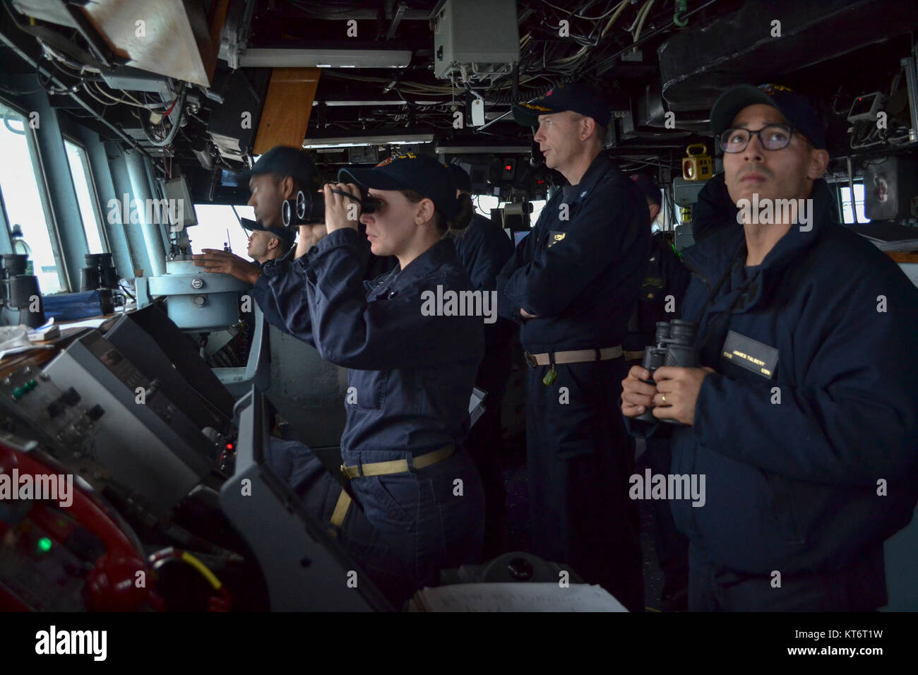 Commanding officer Cmdr. Jim Von St. Paul, center, surveys from the ...