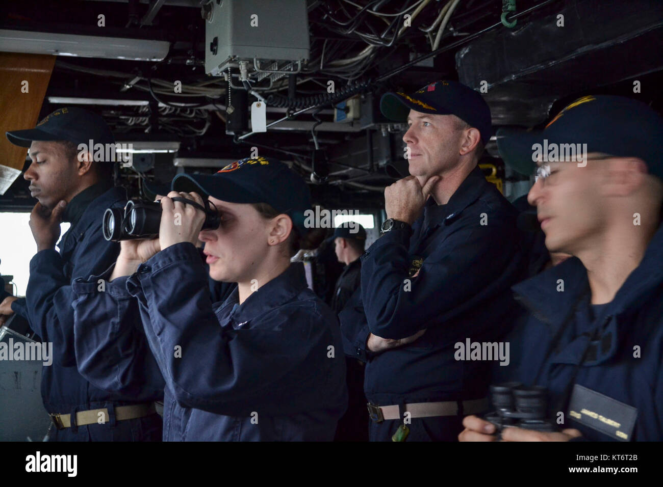 Commanding officer Cmdr. Jim Von St. Paul, center, surveys from the ...