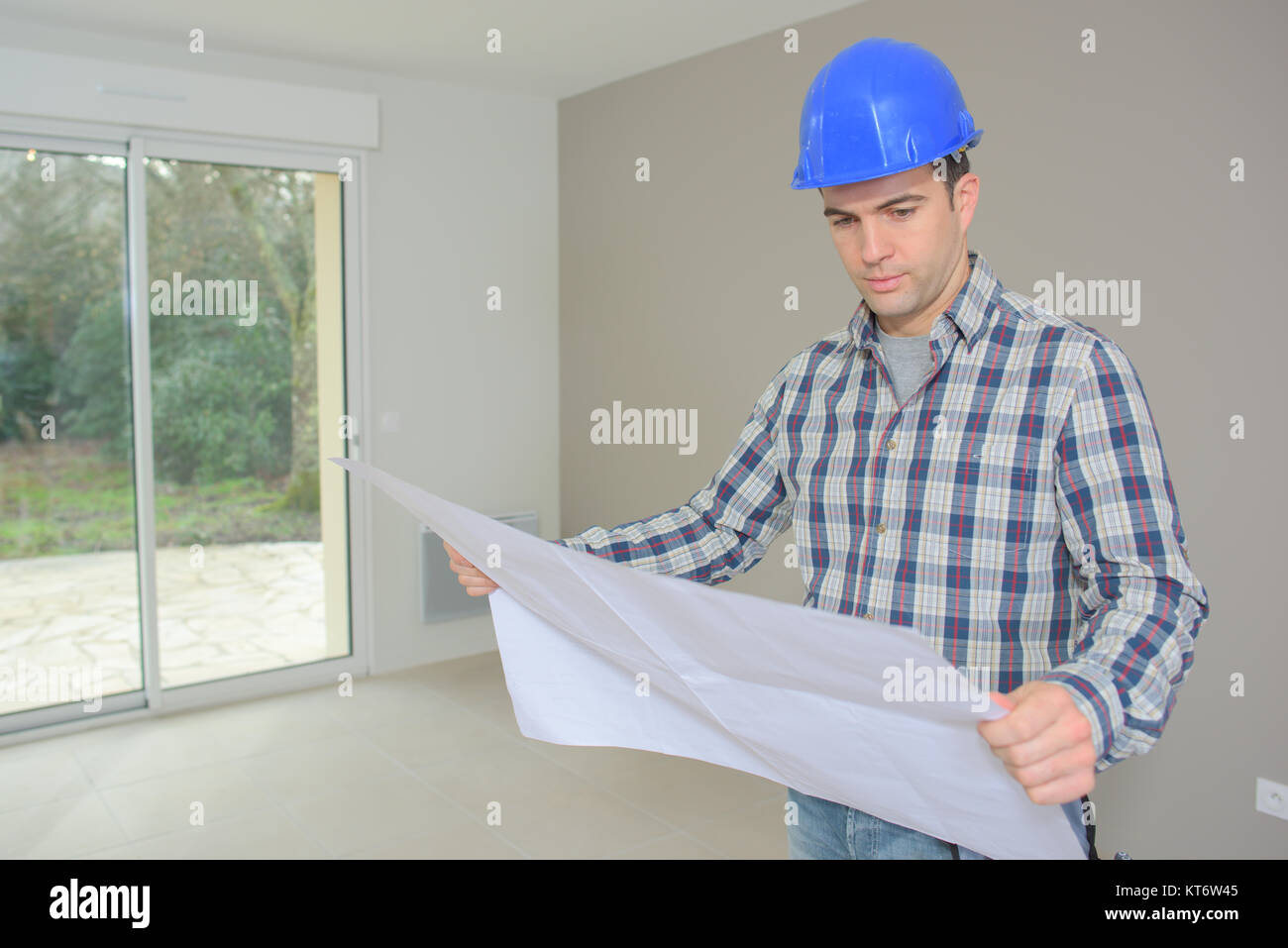 architect checking plans Stock Photo - Alamy