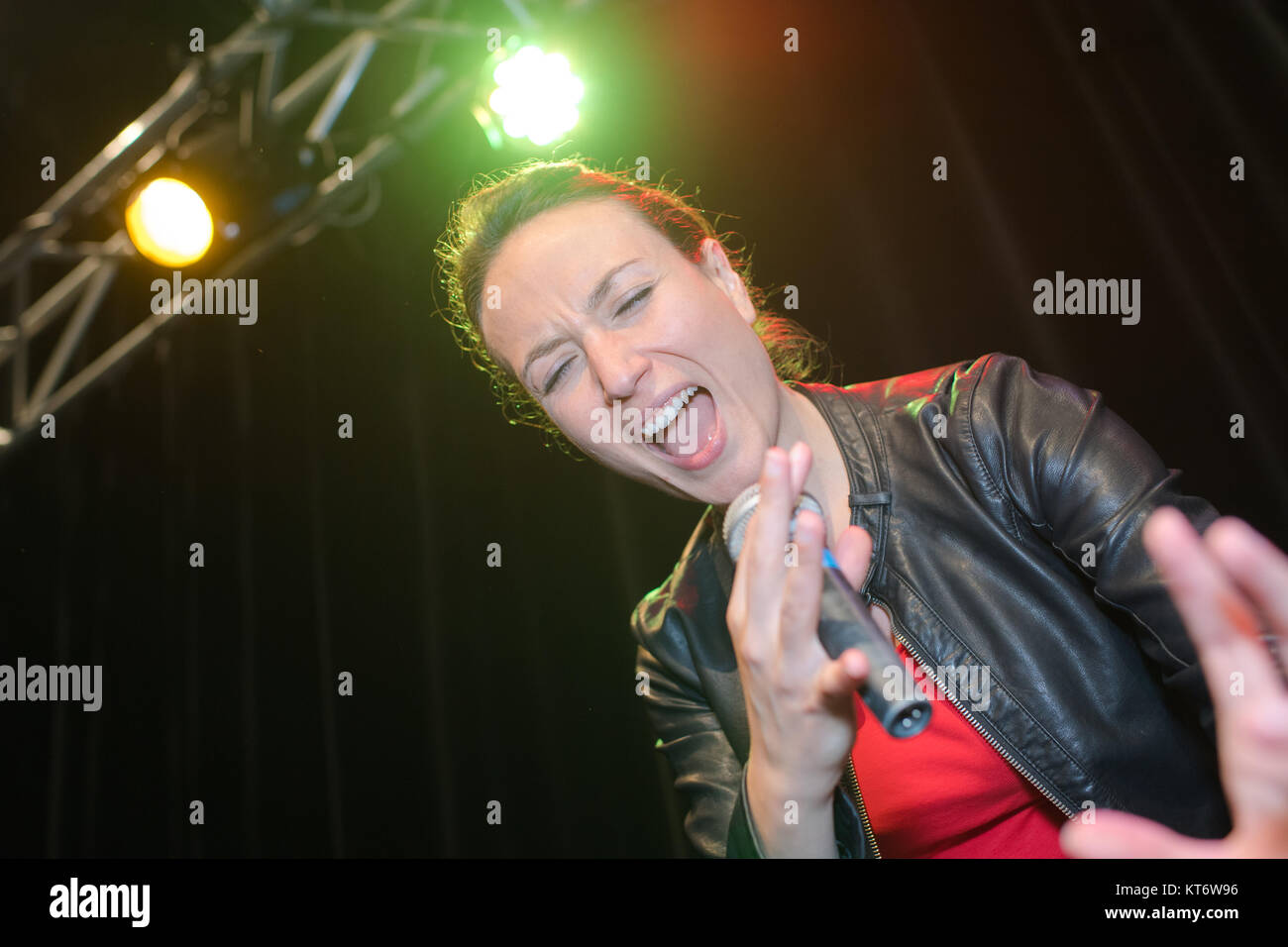 singer hand holding the microphone and singing Stock Photo - Alamy