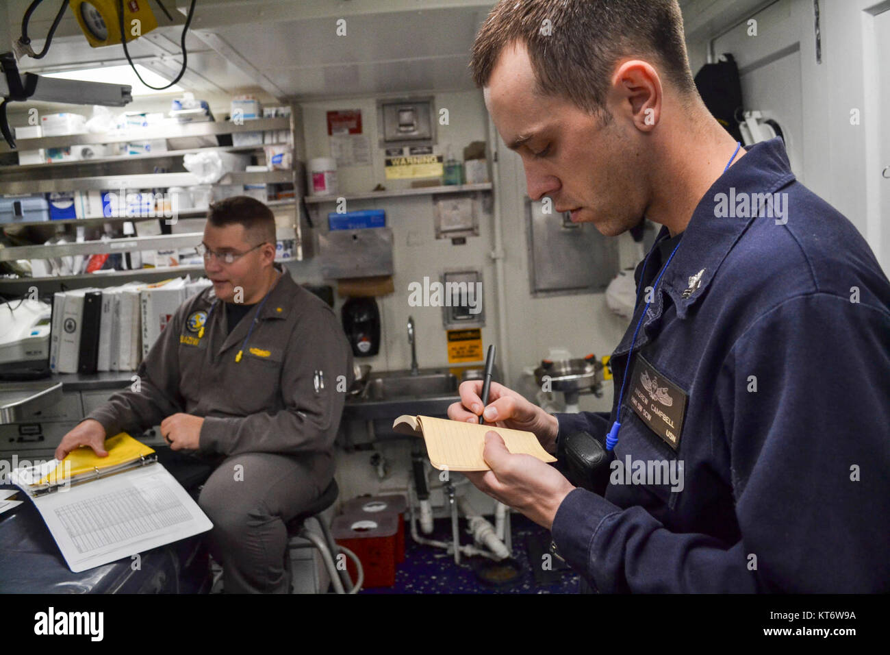 Hospital Corpsman 1st Class Andrew Campbell takes notes from Lt. Mason ...