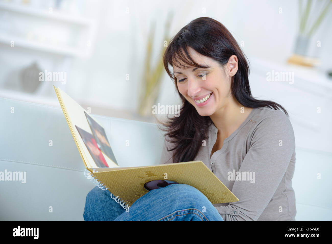 woman checking a photo book Stock Photo - Alamy