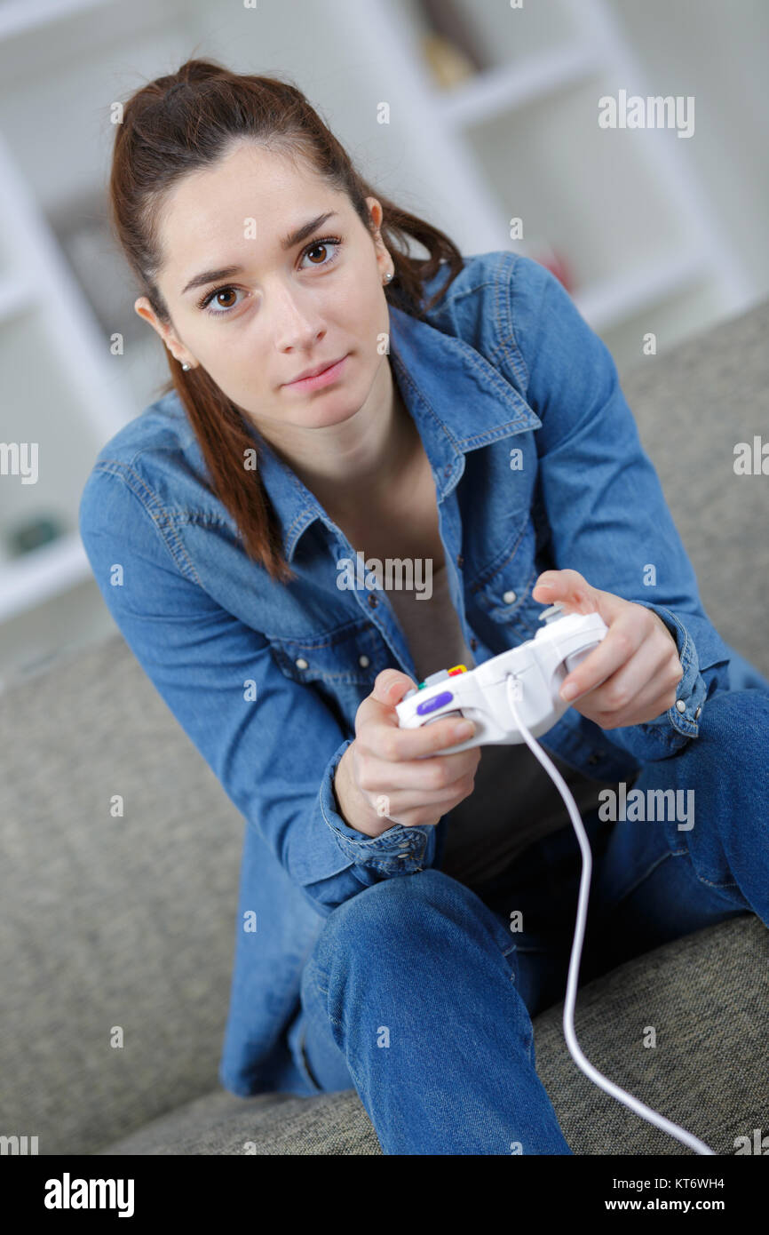portrait of beautiful woman playing videogame at home Stock Photo - Alamy