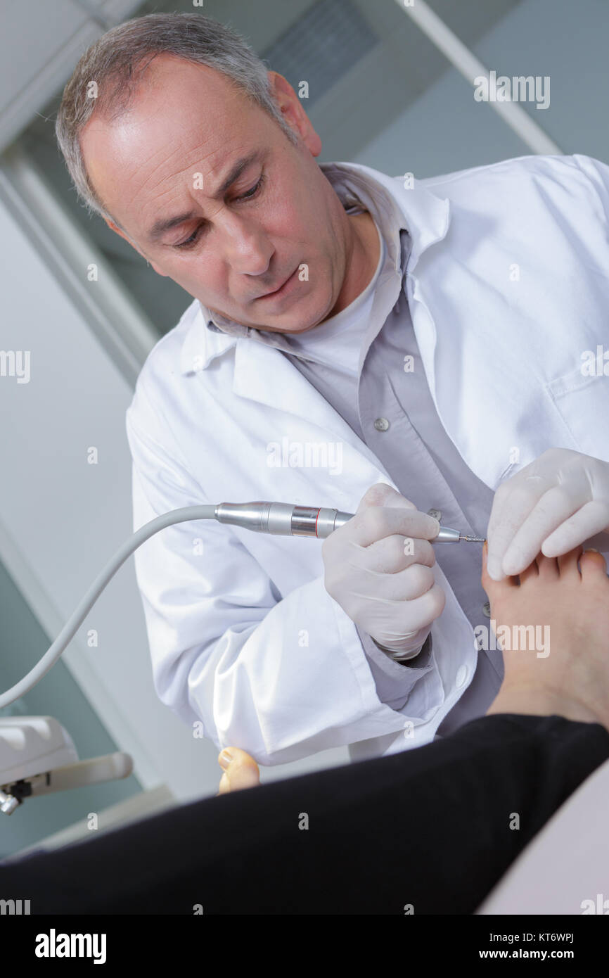 podiatrist in a treatment room with a female customer Stock Photo - Alamy