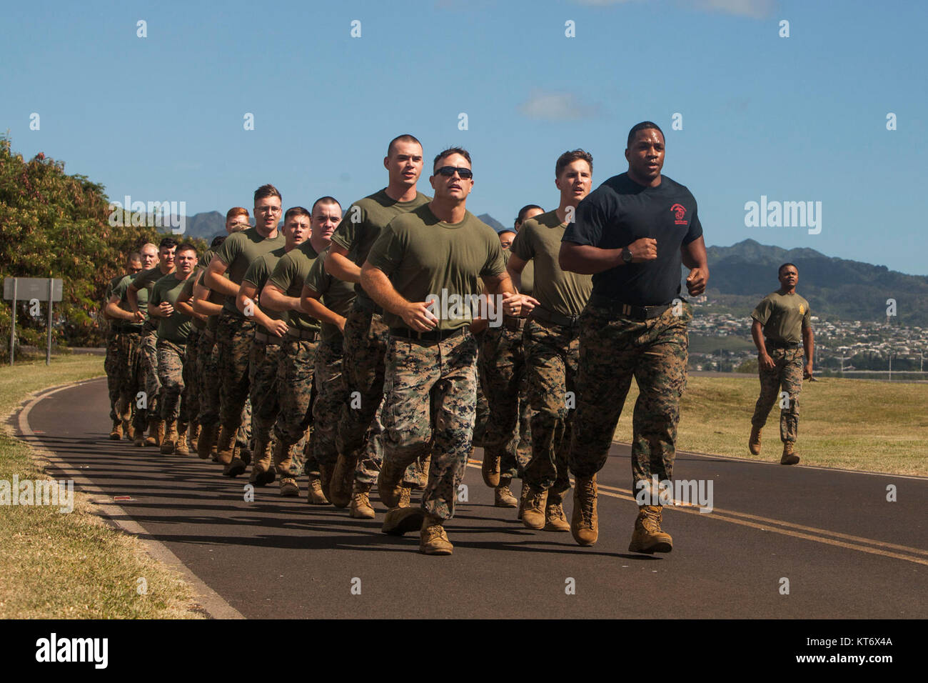 U.S. Marines with 3rd Radio Battalion conduct a formation run during a ...