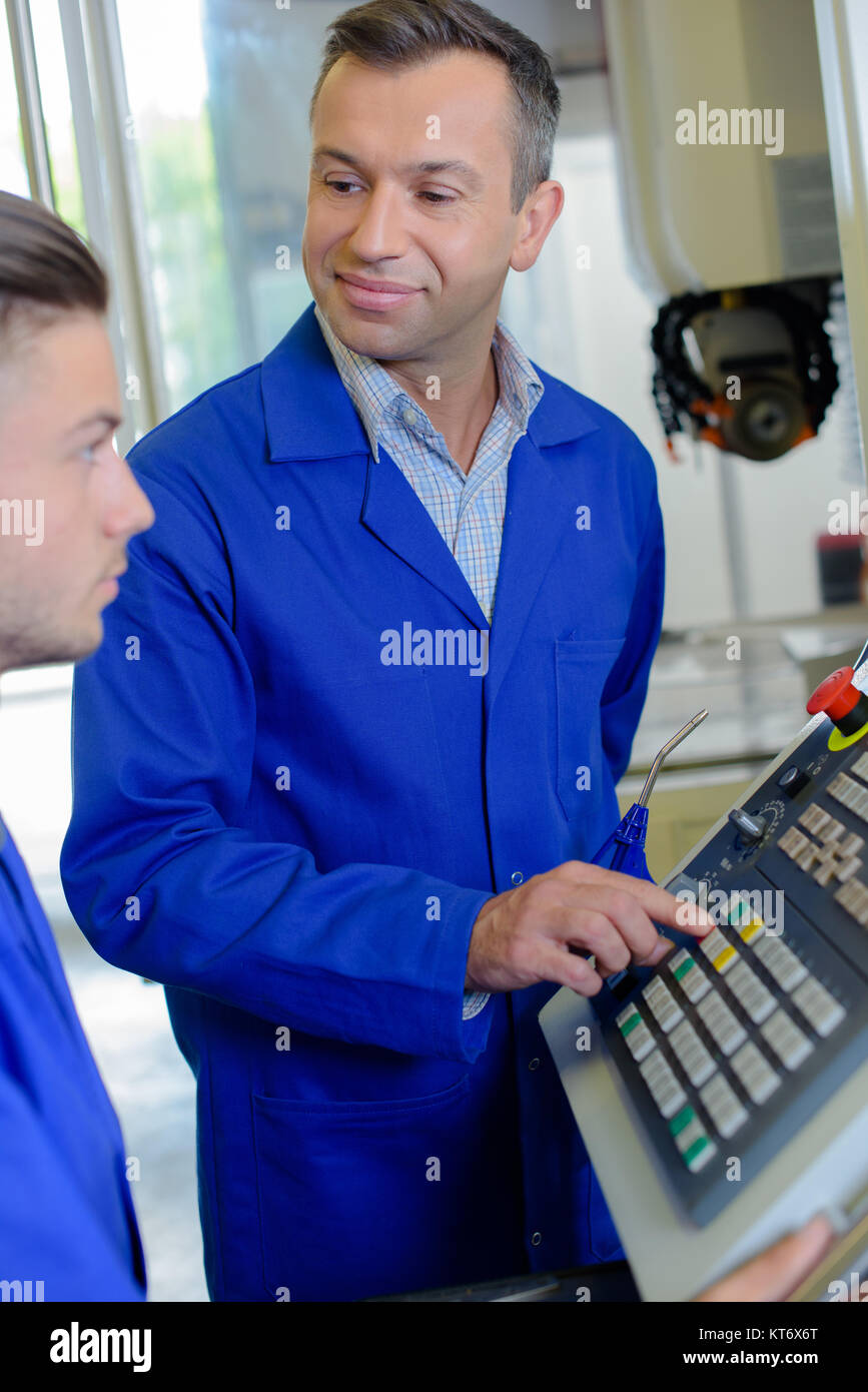 Man worker controls manufacture production hi-res stock photography and ...