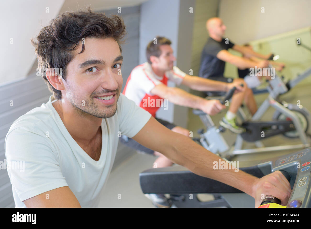 Men on fixed cycling machines Stock Photo - Alamy