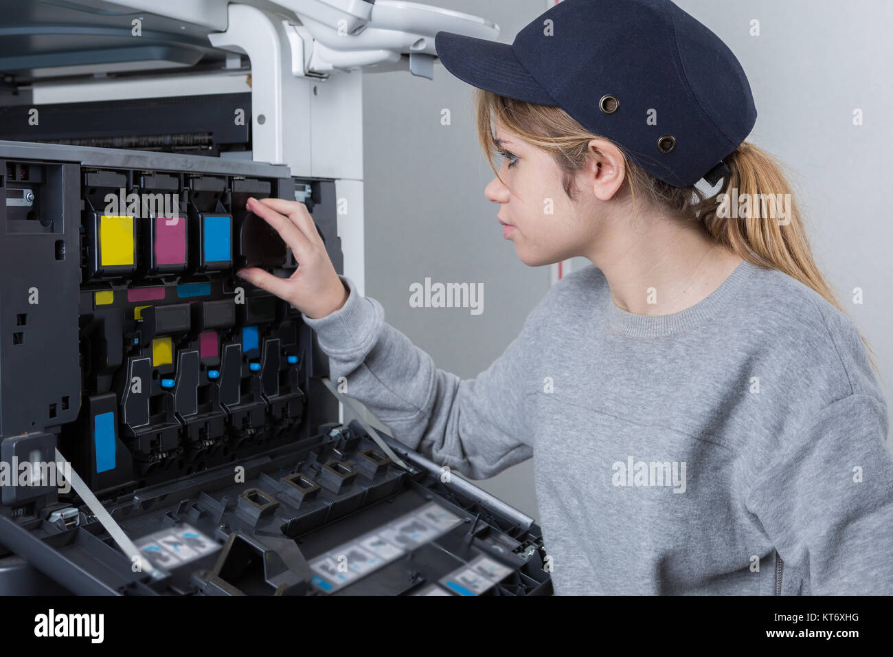 female workers changing ink of a printer Stock Photo - Alamy