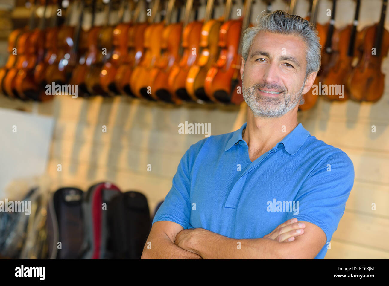 man posing in a violin store Stock Photo - Alamy