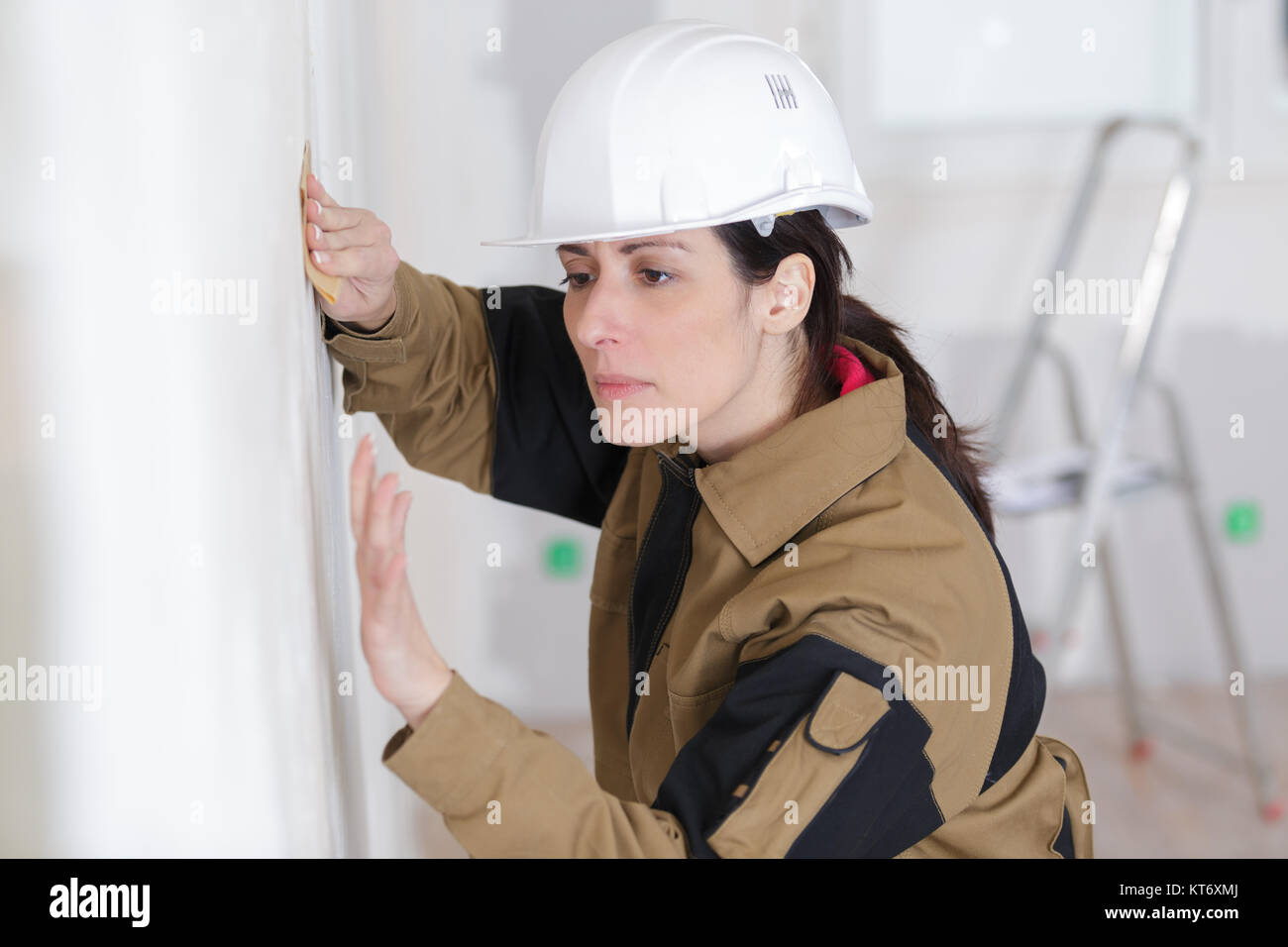 builder female indoor worker plastering wall Stock Photo - Alamy