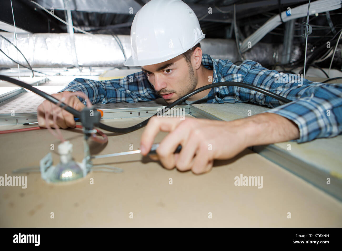 construction worker working in the ceiling Stock Photo - Alamy