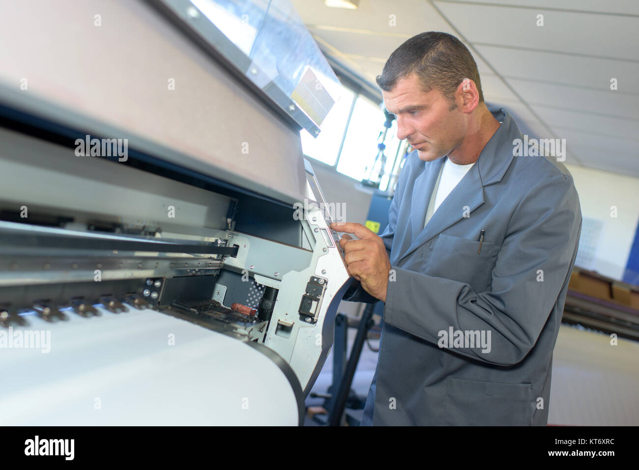 Man programming machine Stock Photo - Alamy