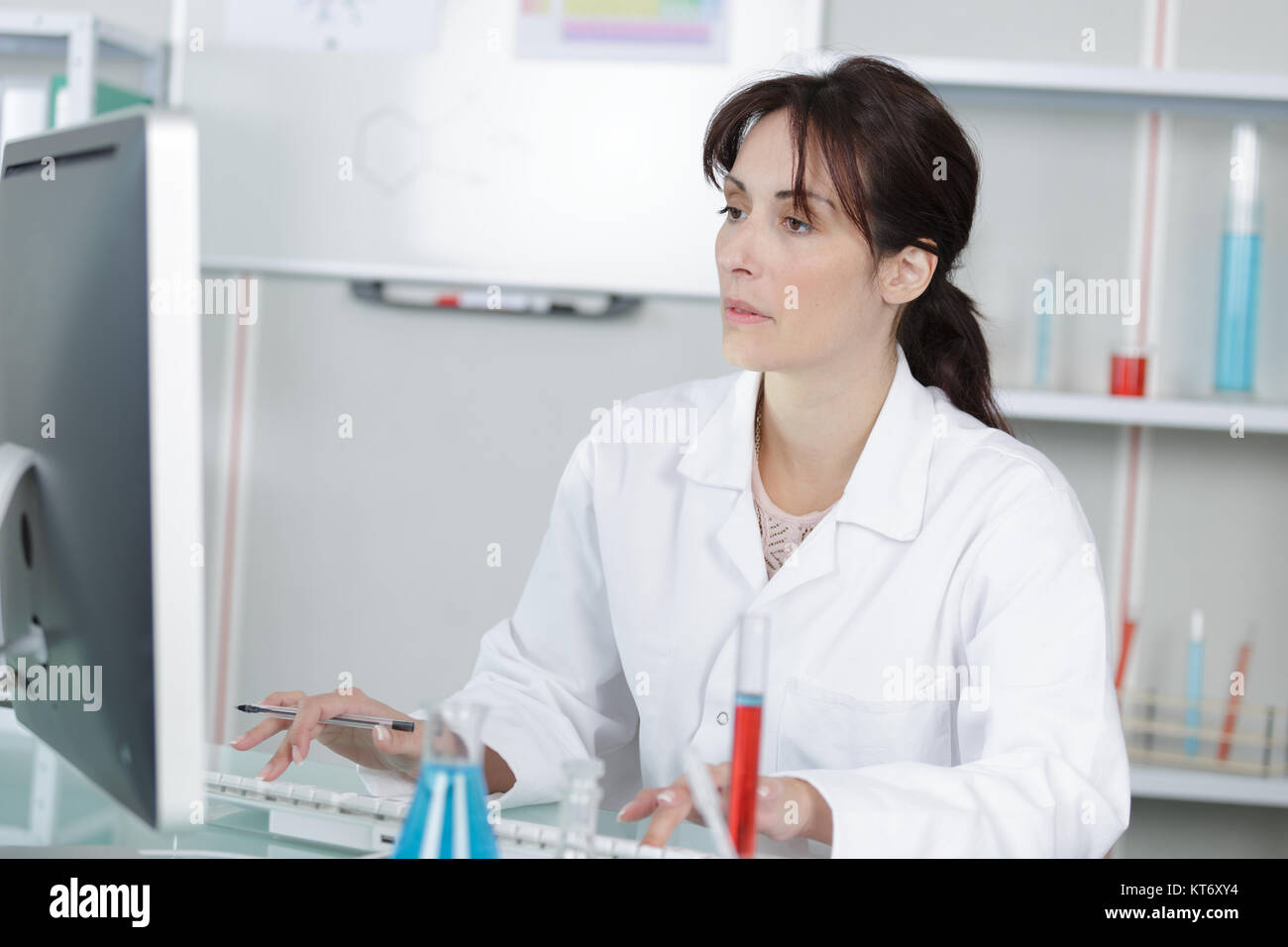 young female scientist working with liquids in laboratory Stock Photo ...