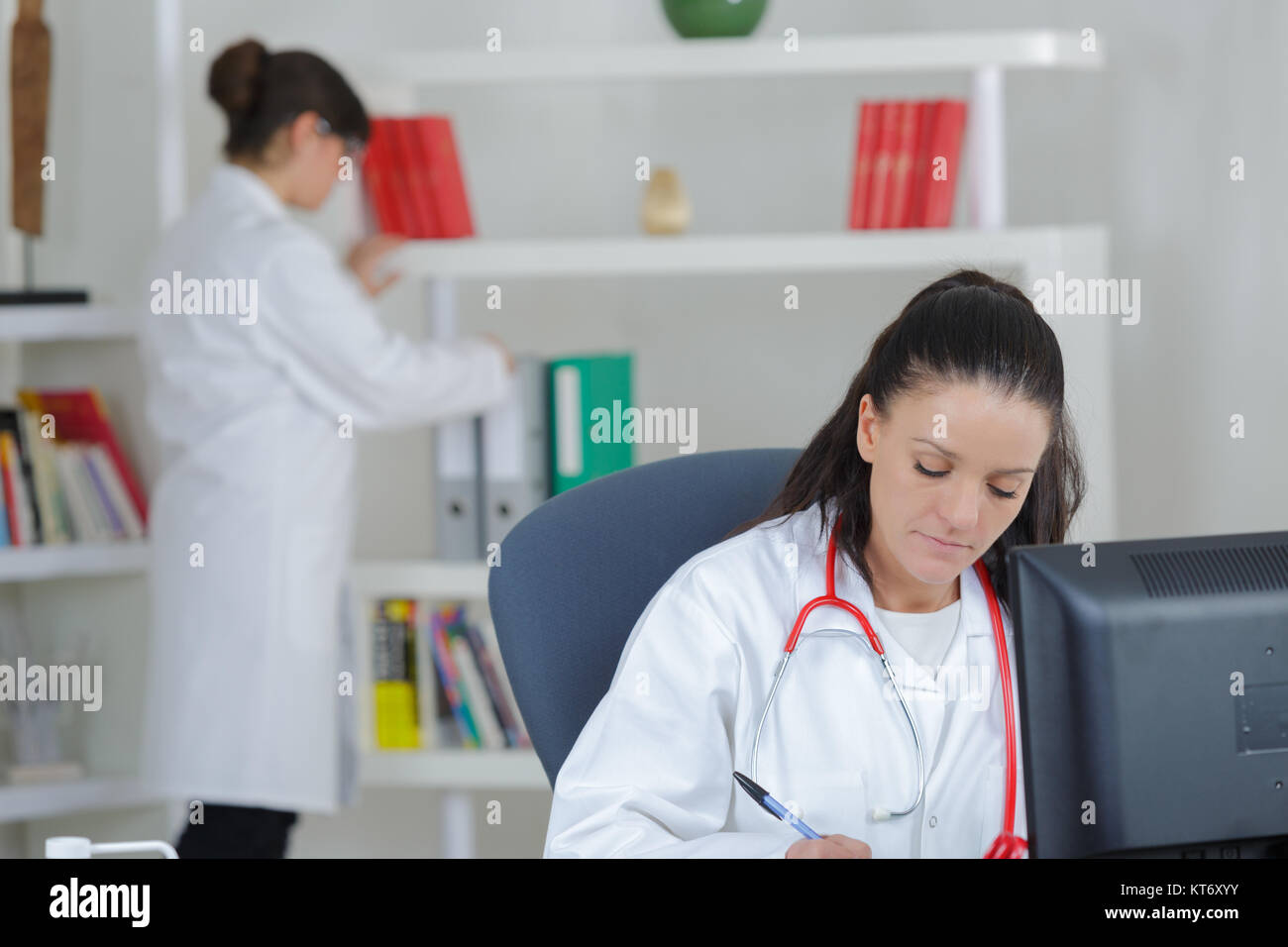 female doctor using her laptop computer at clinic Stock Photo - Alamy