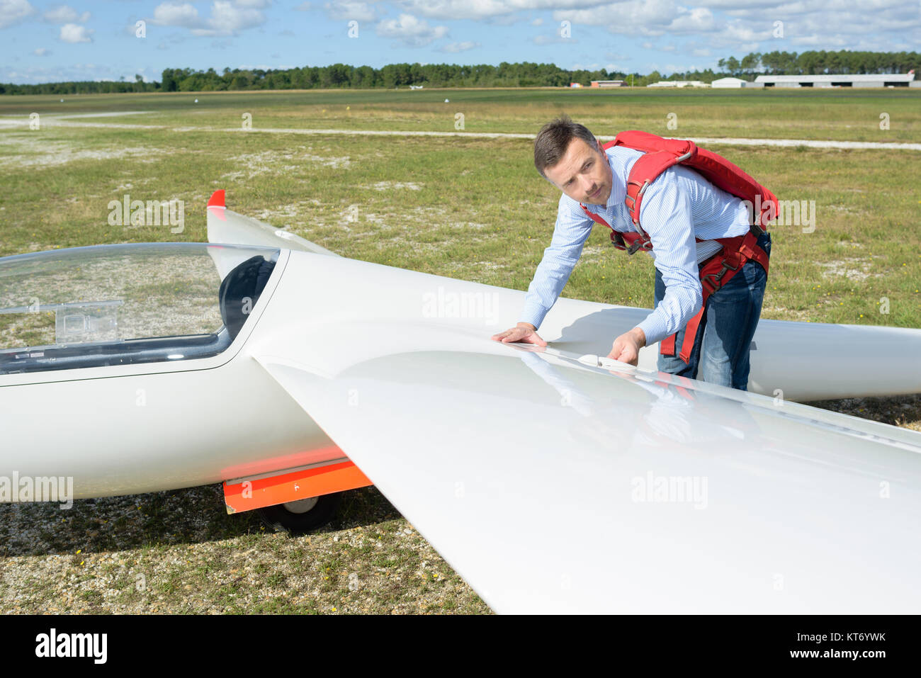 Pilot looking at wing of sailplane Stock Photo - Alamy